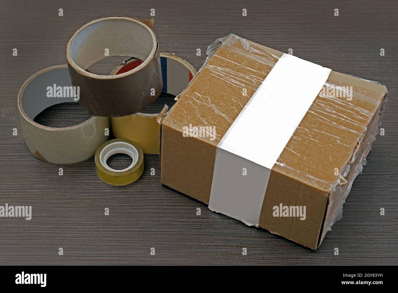 Closed cardboard box with duct tapes on table inside distribution ...