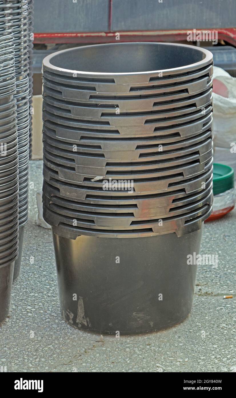 Stack of empty plastic buckets sold on outdoor market Stock Photo - Alamy