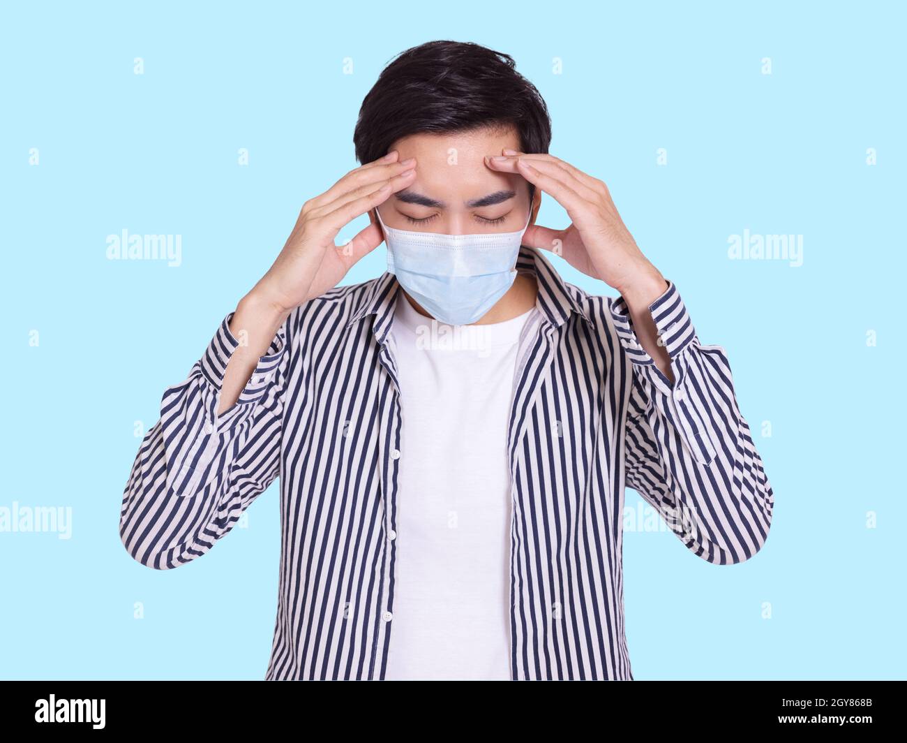 The handsome young man felt uncomfortable touching his head and wearing ...