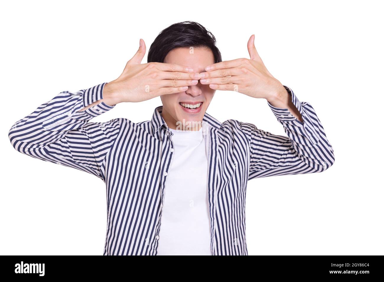 young man covering eyes with hands and laughing.Isolated on white ...