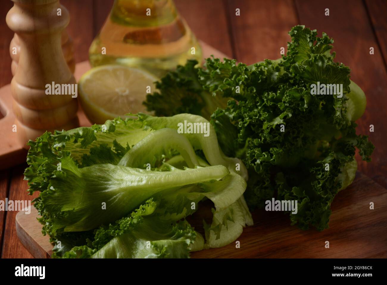 Green Batavia lettuce leaves on wooden background. Ready for cooking ...
