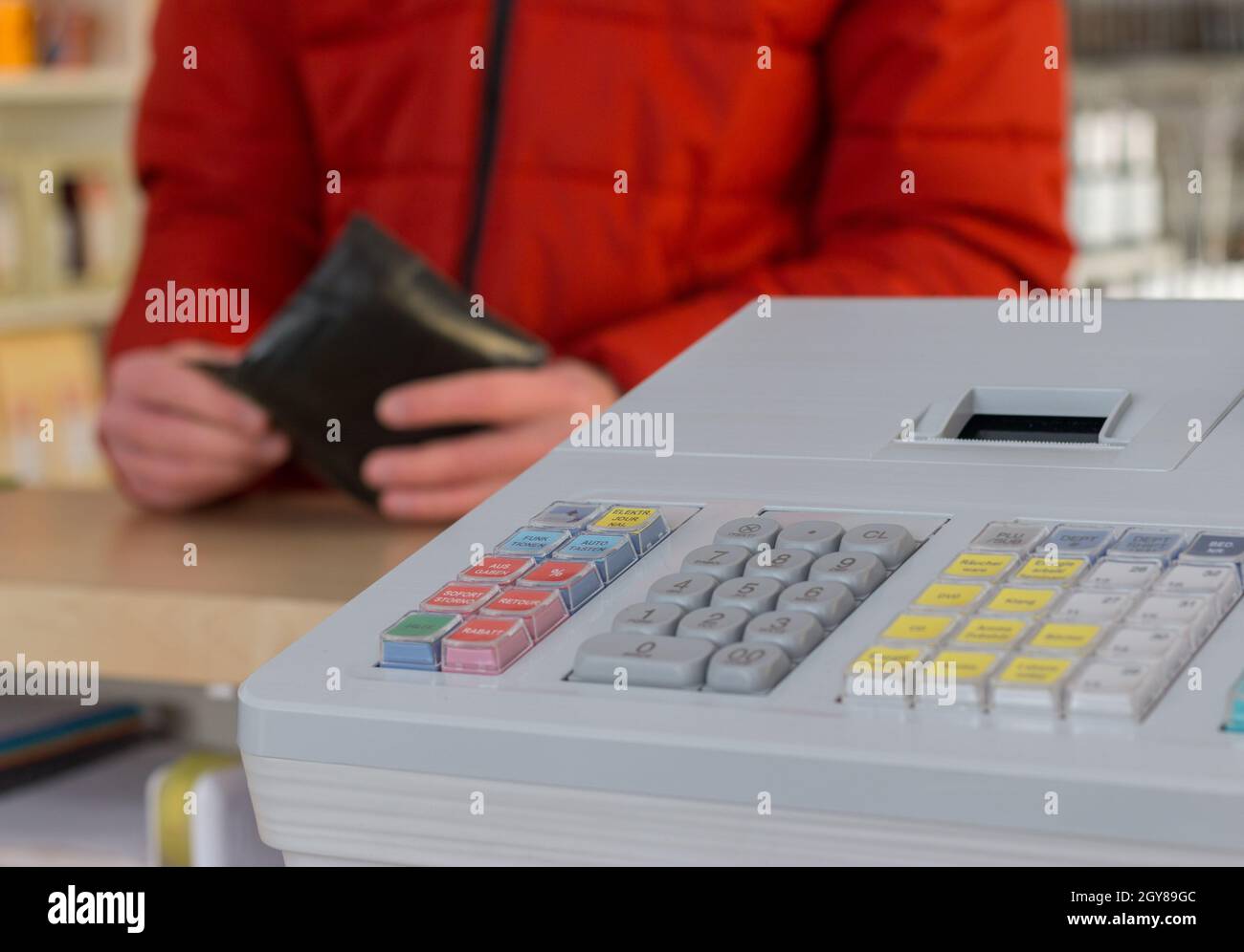 Cash register in a shop: Customer is paying purchase Stock Photo - Alamy