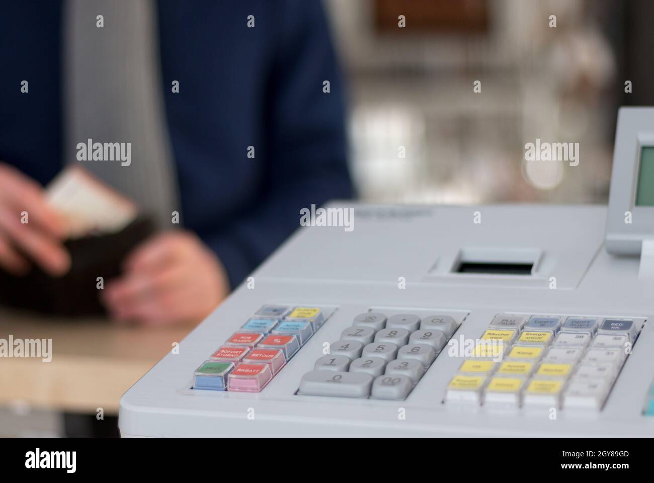 Cash register in a shop: Customer is paying purchase Stock Photo - Alamy