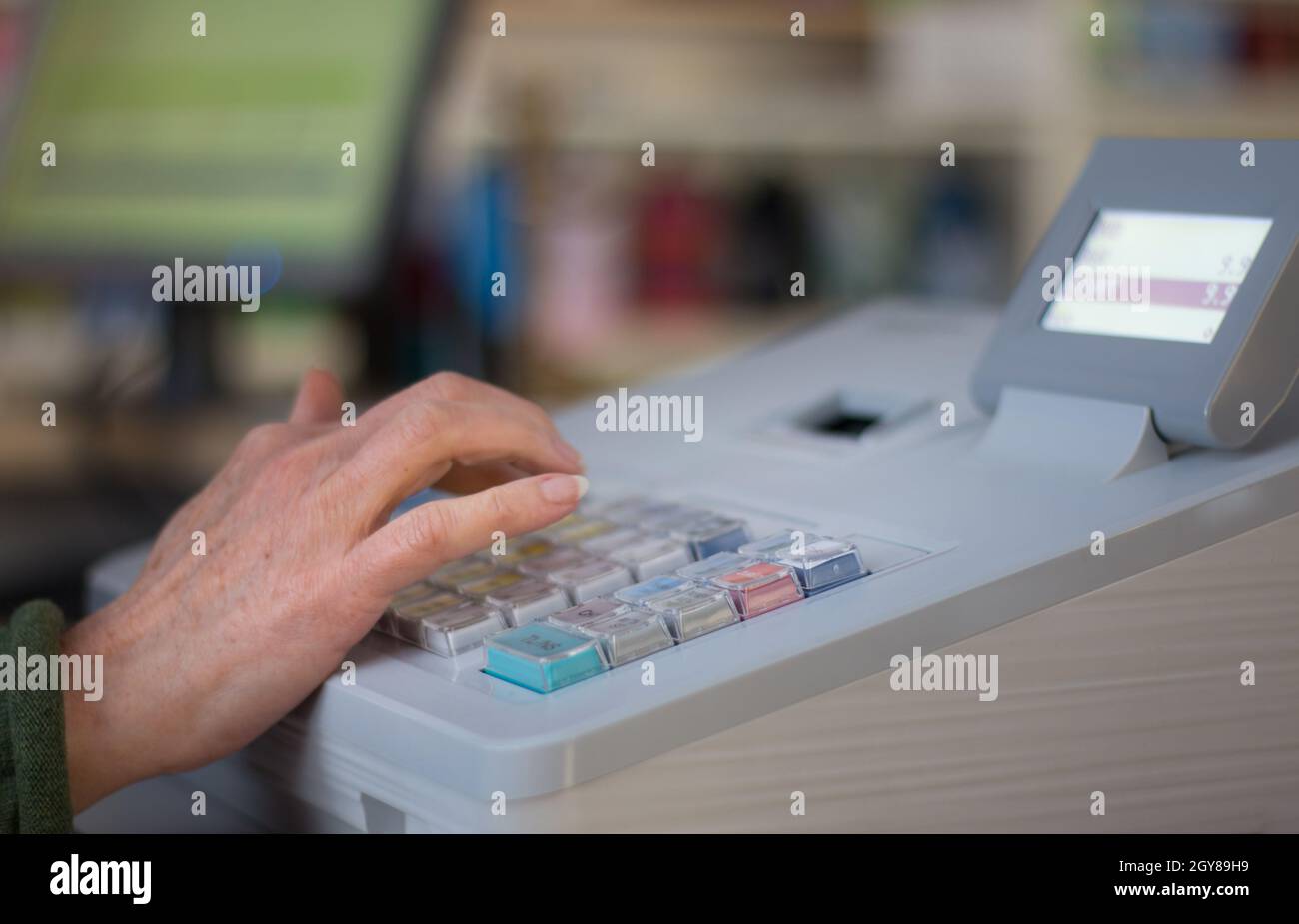 Cash register in a shop: Customer is paying purchase Stock Photo - Alamy