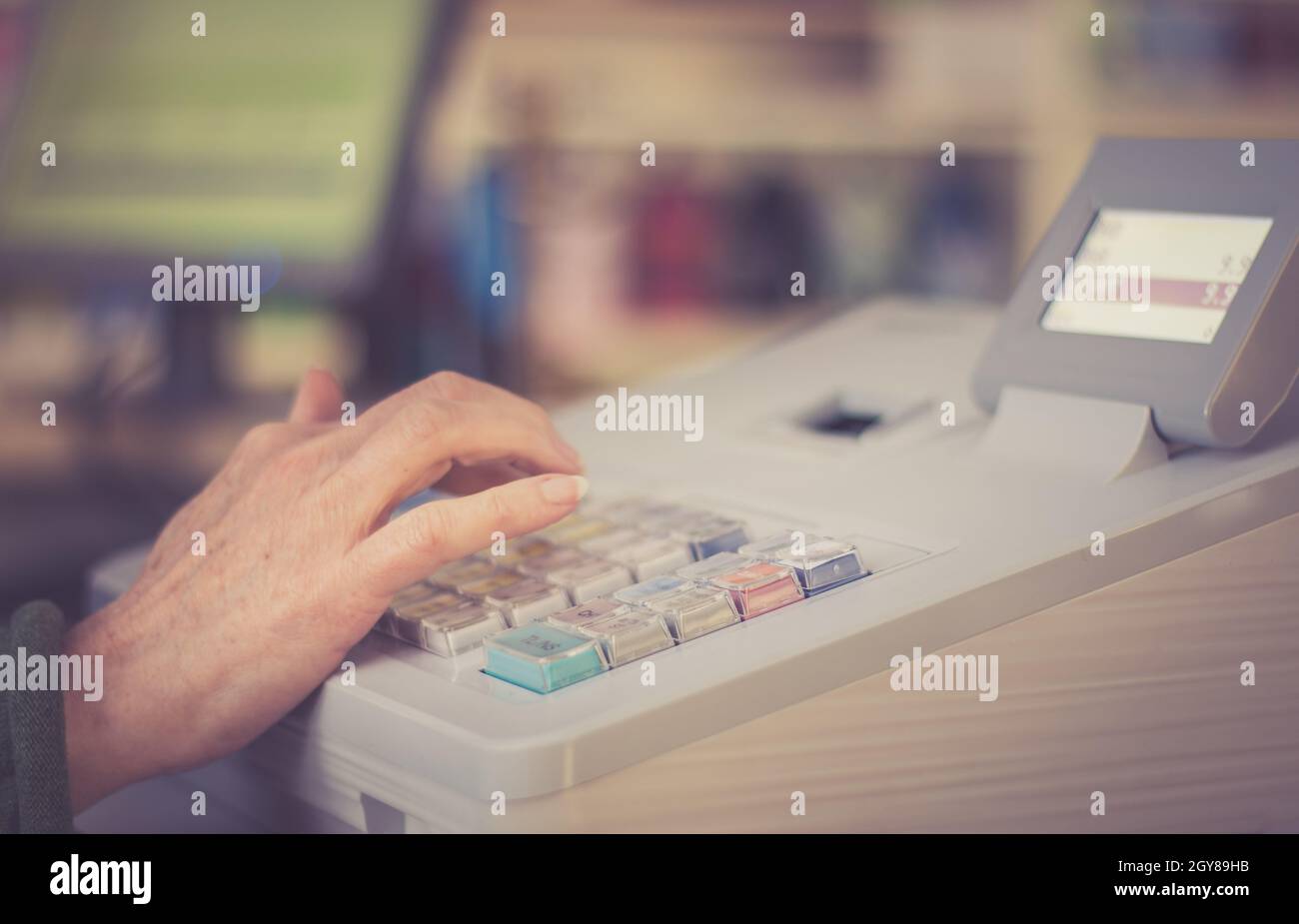 Cash register in a shop: Customer is paying purchase Stock Photo - Alamy