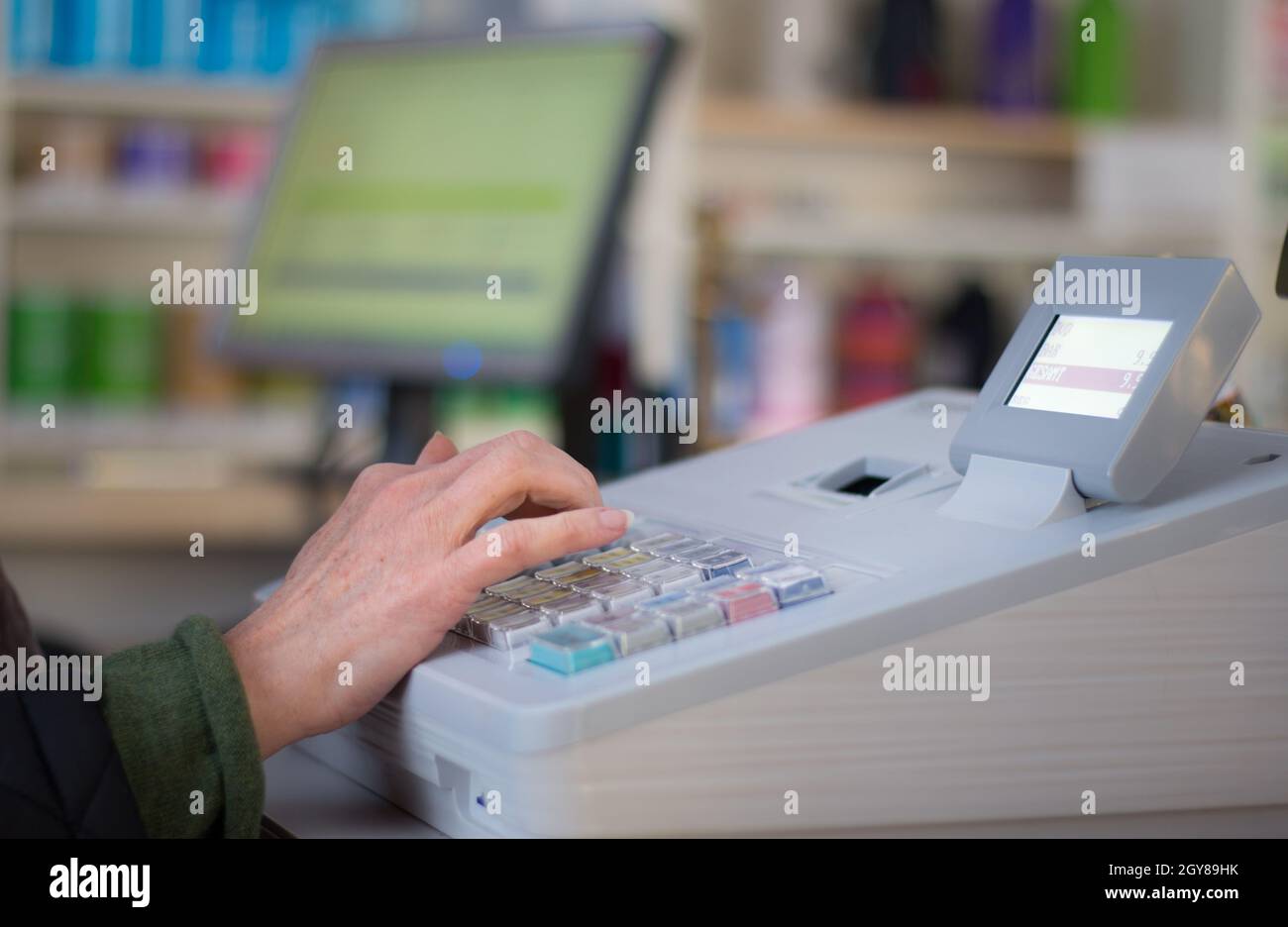 Cash register in a shop: Customer is paying purchase Stock Photo - Alamy