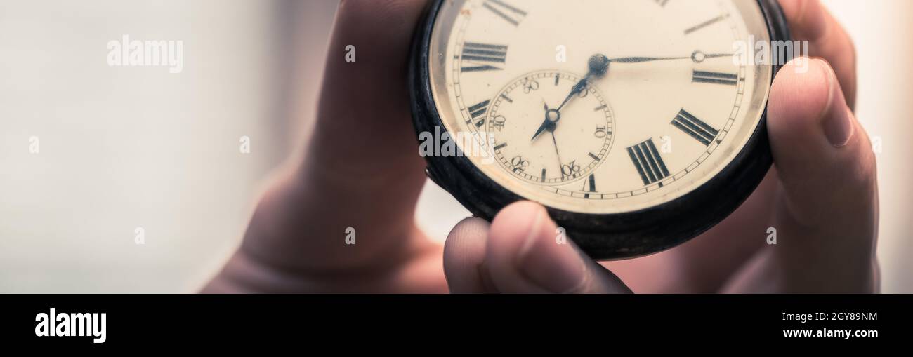 Time goes by: Man is holding a vintage watch in his hand, business ...