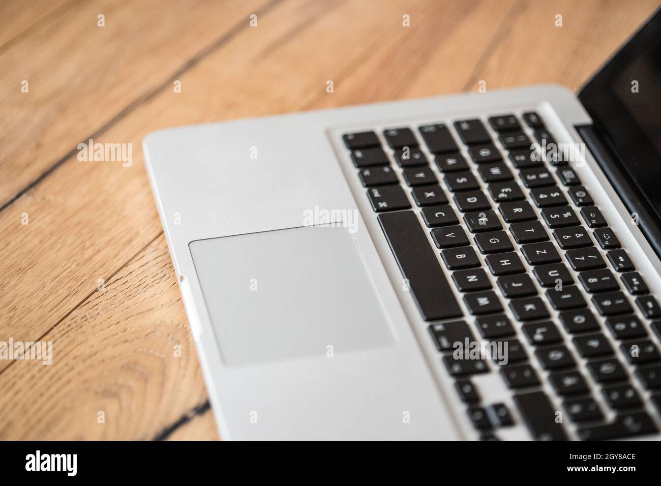 Close up of a laptop keyboard on a rustic wooden desk Stock Photo - Alamy