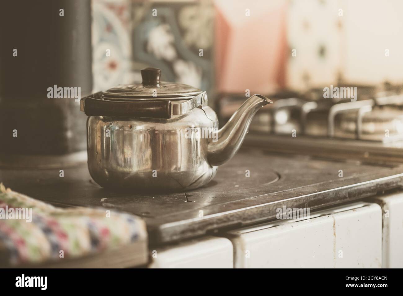 Metal tea cooker on a rustic old oven Stock Photo - Alamy