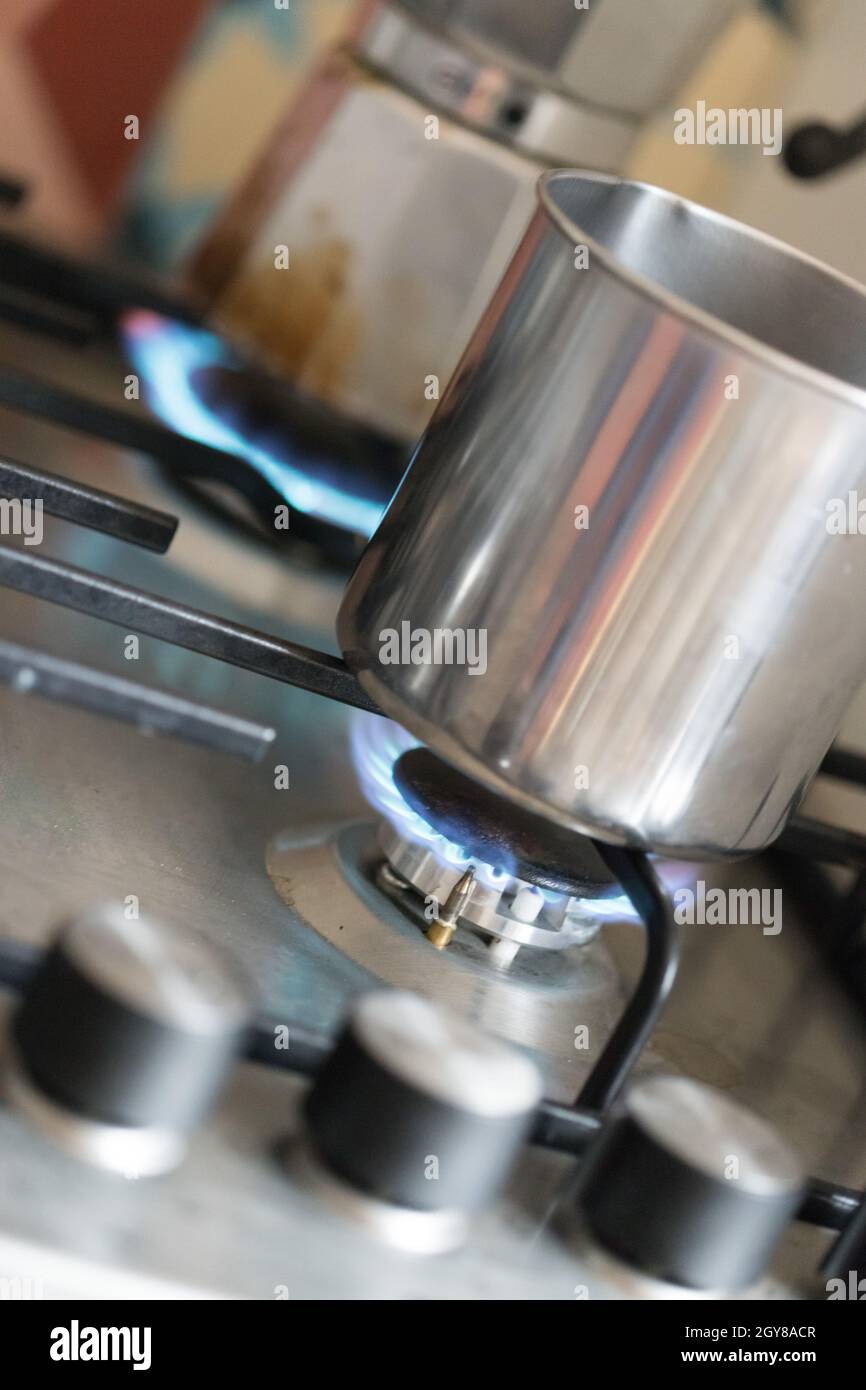 Close up of a blue gas flame, cooking a water pot in kitchen Stock ...