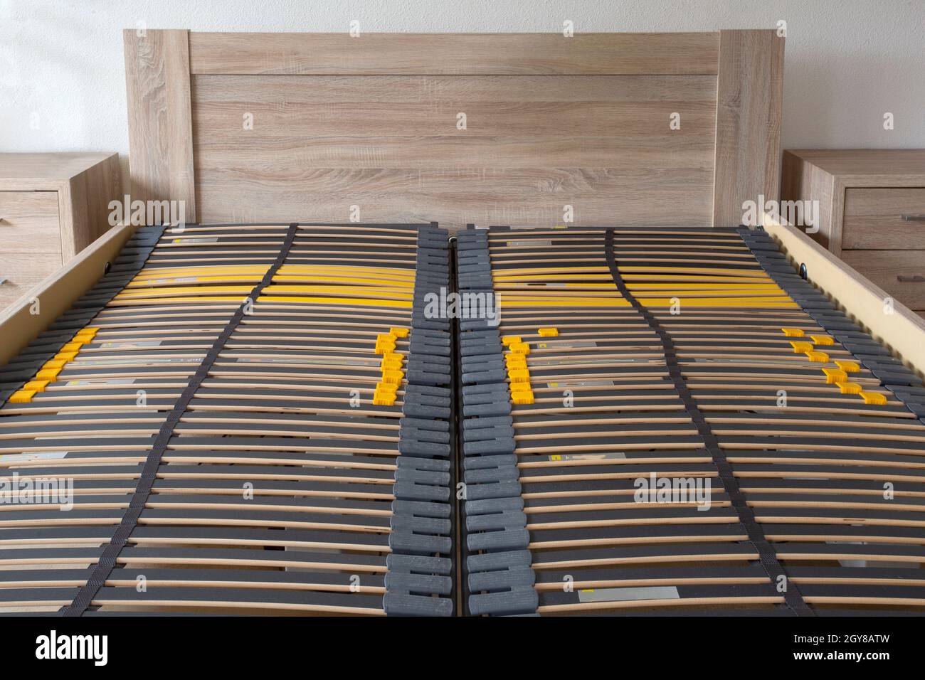 Slatted base, wooden element double bed frame close up in bedroom ...