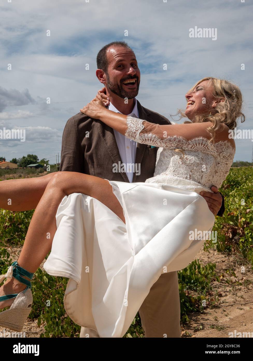Happy Spanish couple hugging during the wedding ceremony Stock Photo ...
