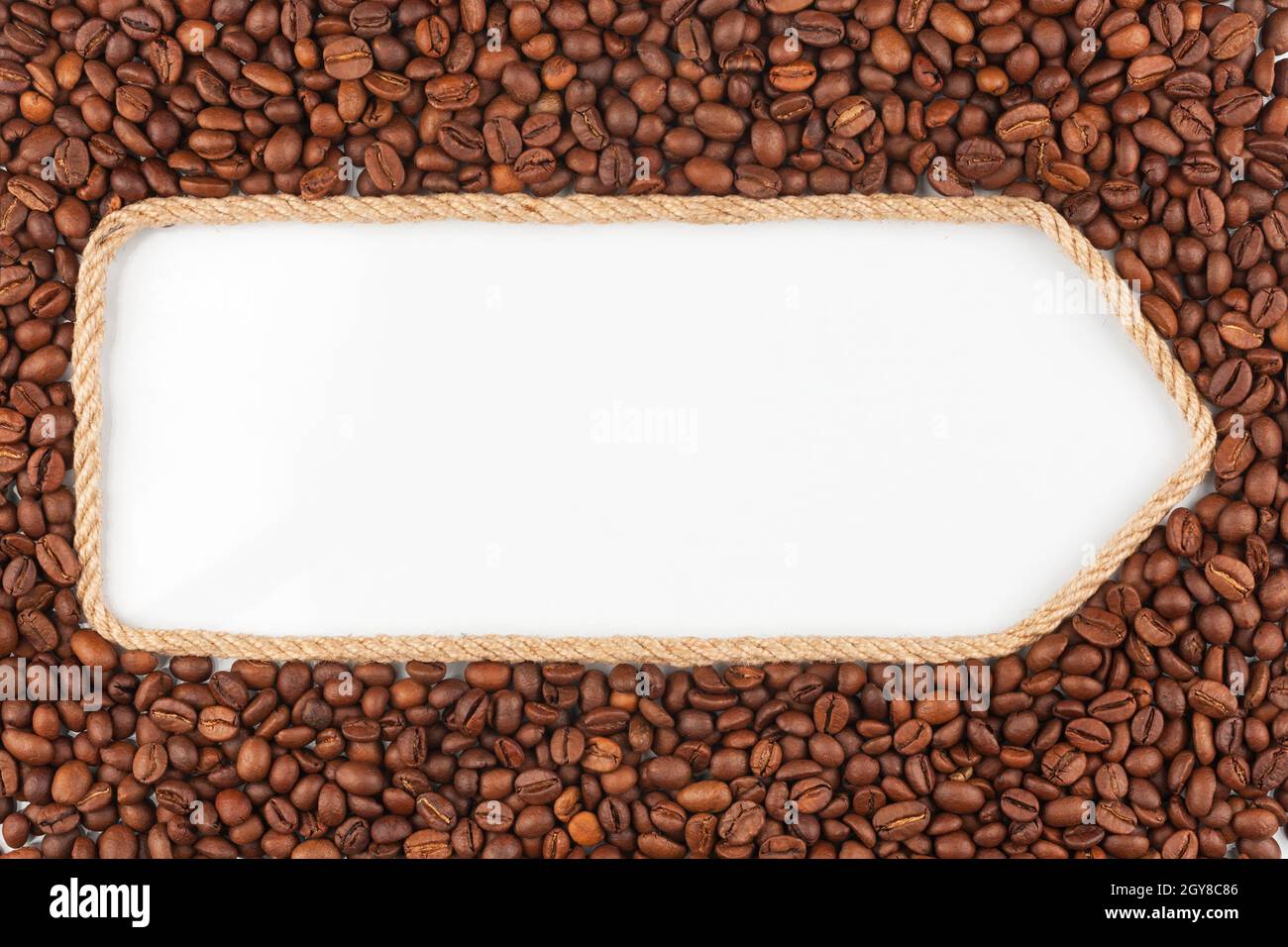 Pointer made from rope with coffee beans lying on a white background ...