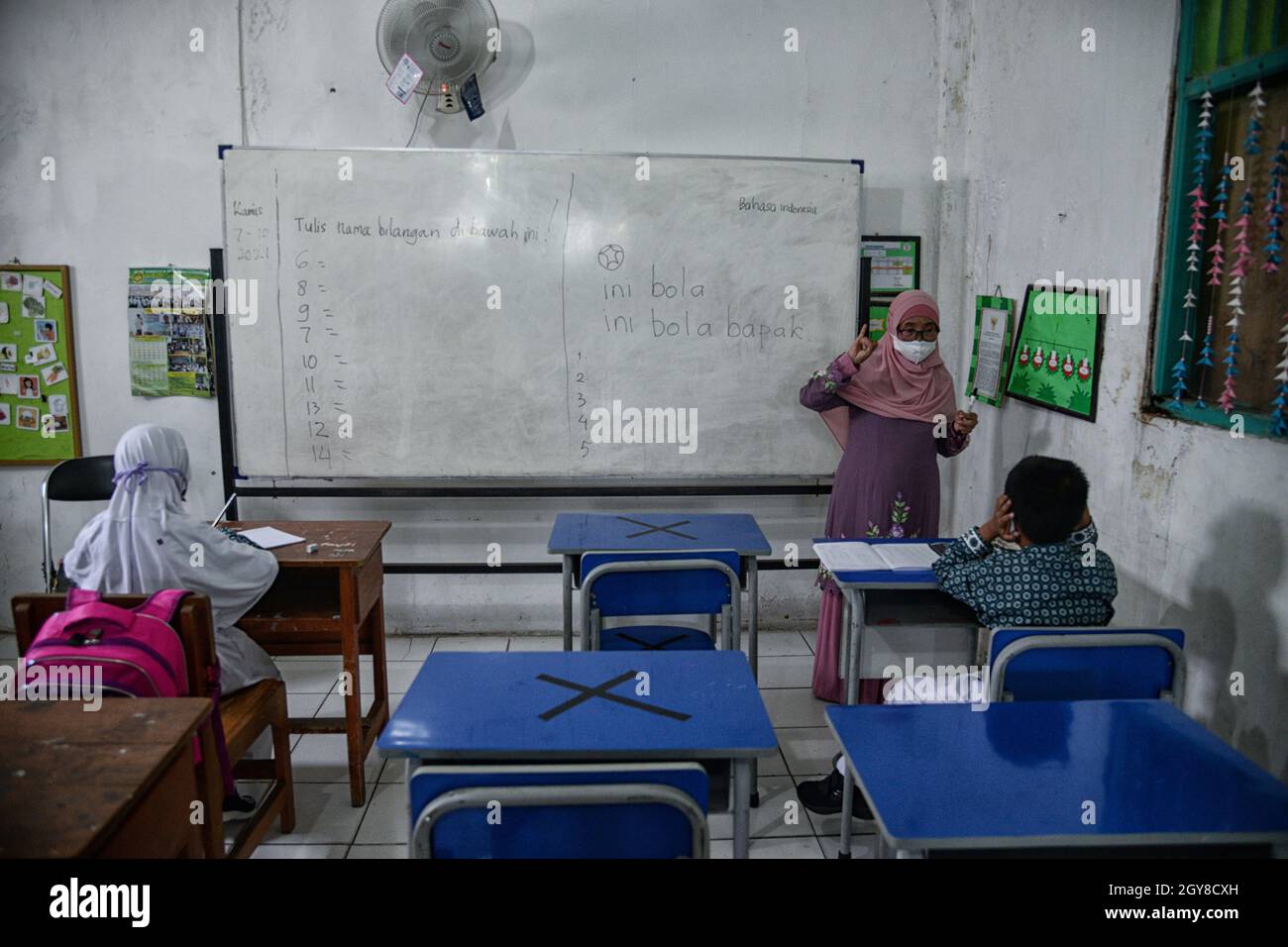 A teacher is seen teaching students with intellectual disabilities at a ...