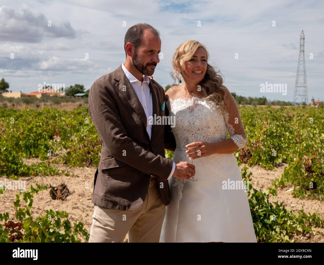 Happy Spanish couple drinking champagne during the wedding ceremony ...