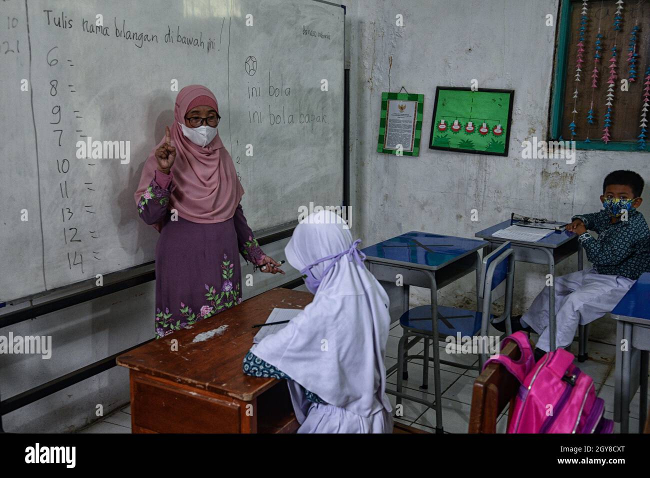 A teacher is seen teaching students with intellectual disabilities at a ...