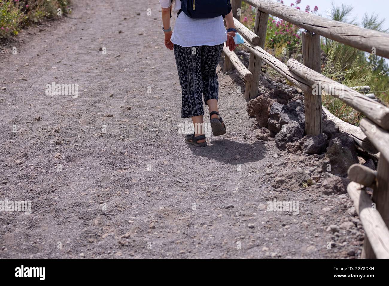 Tourist walking along the footpath to the top of Vesuvius volcano on a ...