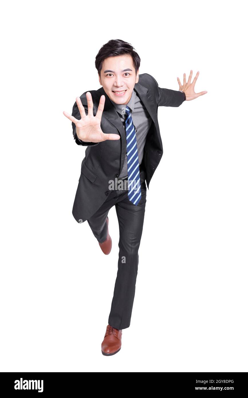 Young handsome businessman running fast and grabbing forward.Isolated ...