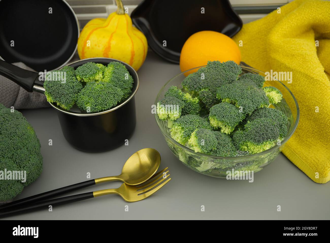 Broccoli preparation for cooking on the kitchen table, broccoli florets ...
