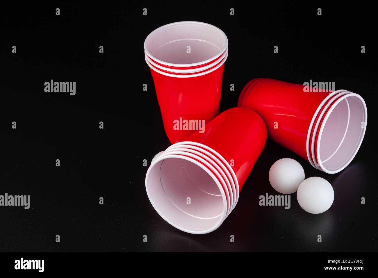 Red plastic cups and ball for game of beer pong Stock Photo - Alamy