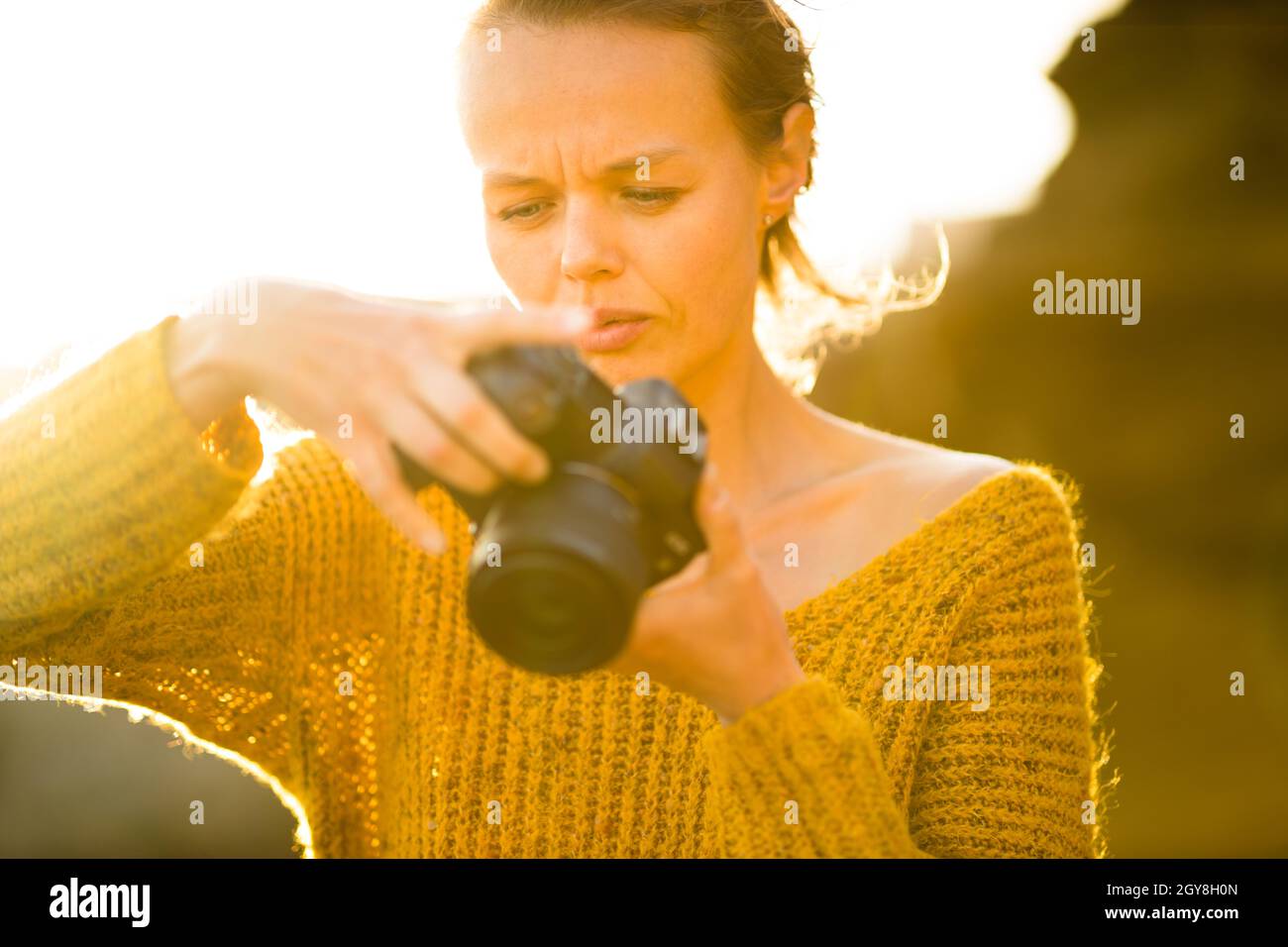 Hobby photographer concept. Outdoor lifestyle portrait of young woman ...