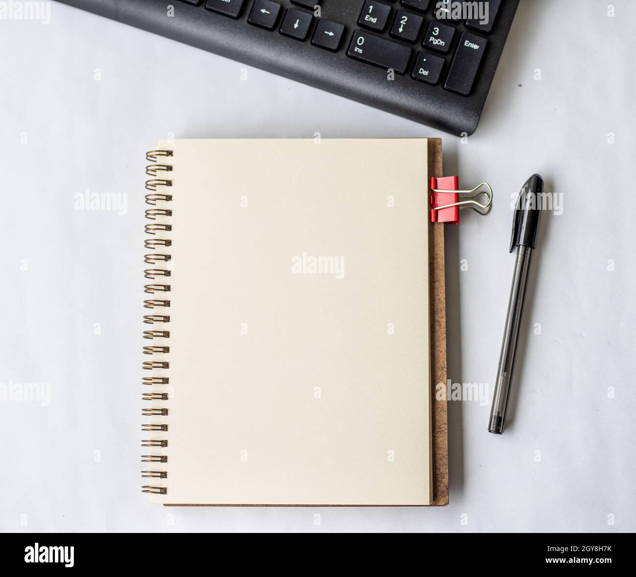 Empty Open Journal With A Clip And A Pen Beside A Keyboard On A Desk ...