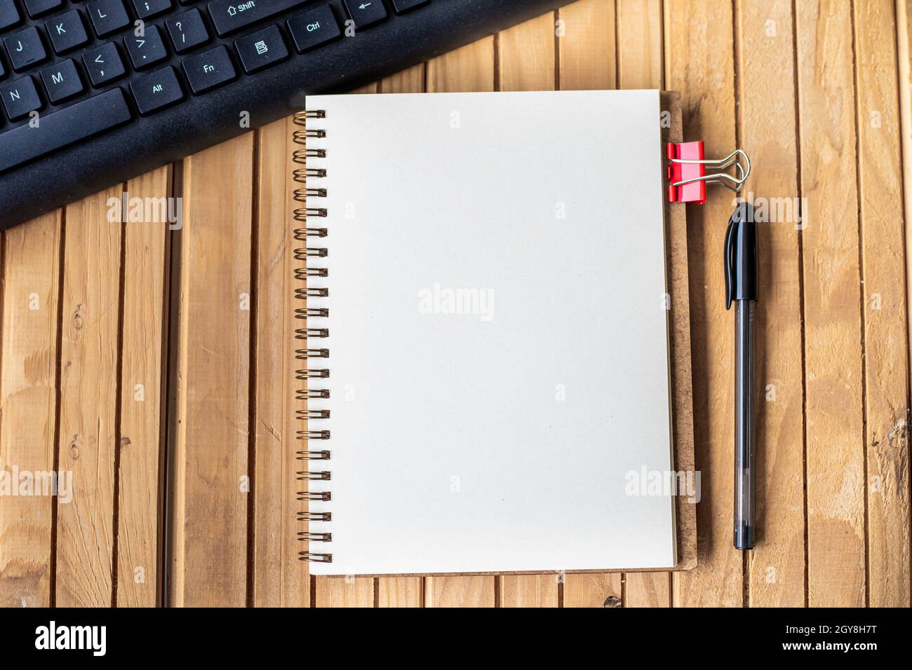 Empty Open Journal With A Clip And A Pen Beside A Keyboard On A Desk ...