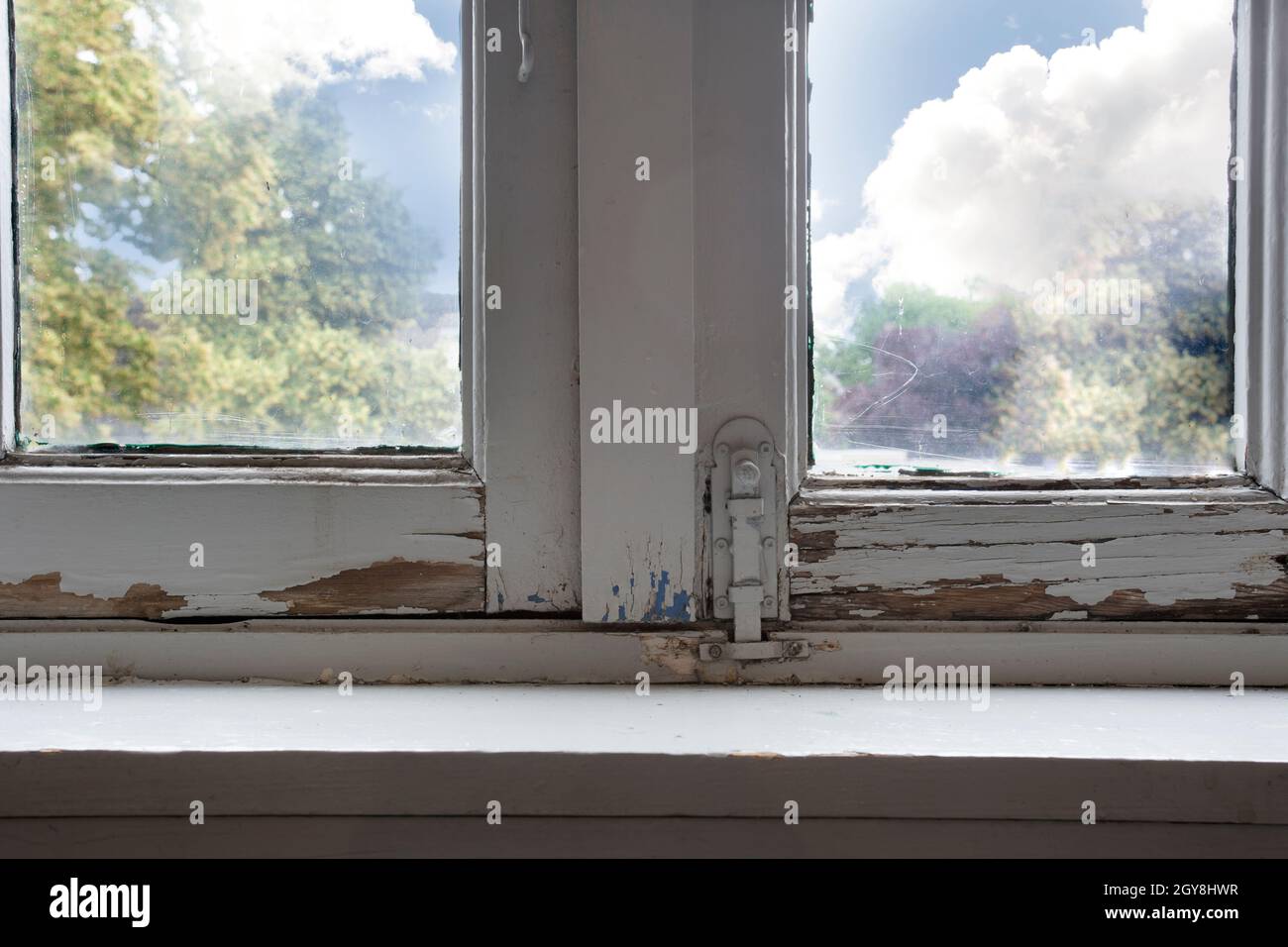 Old wooden window frames with rotting wood and cracked peeling paint ...