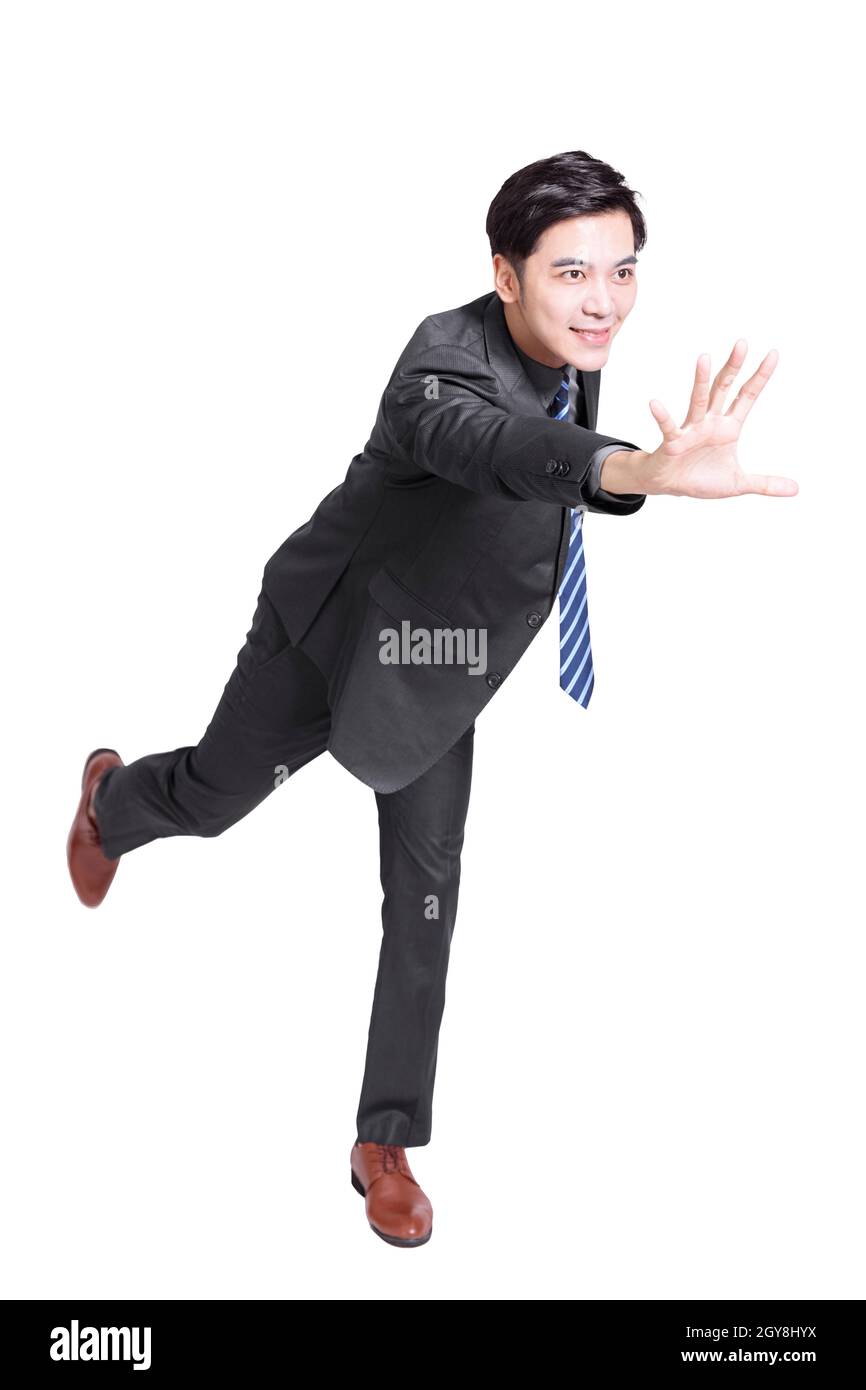 Young handsome businessman running fast and grabbing forward.Isolated ...