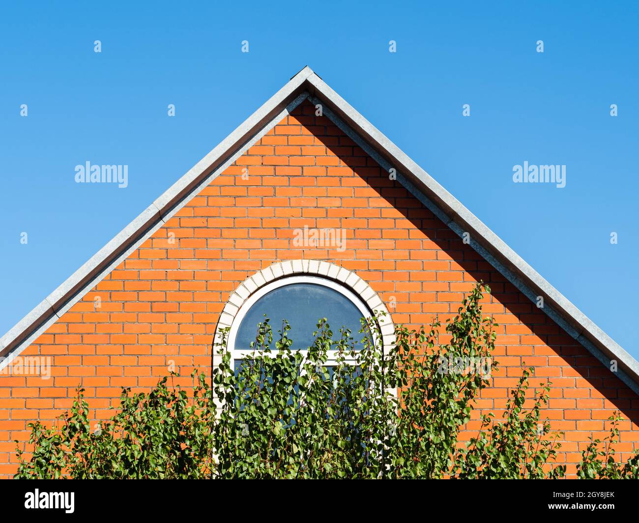 blue sky over brick gable wall with window of house on sunny day Stock ...