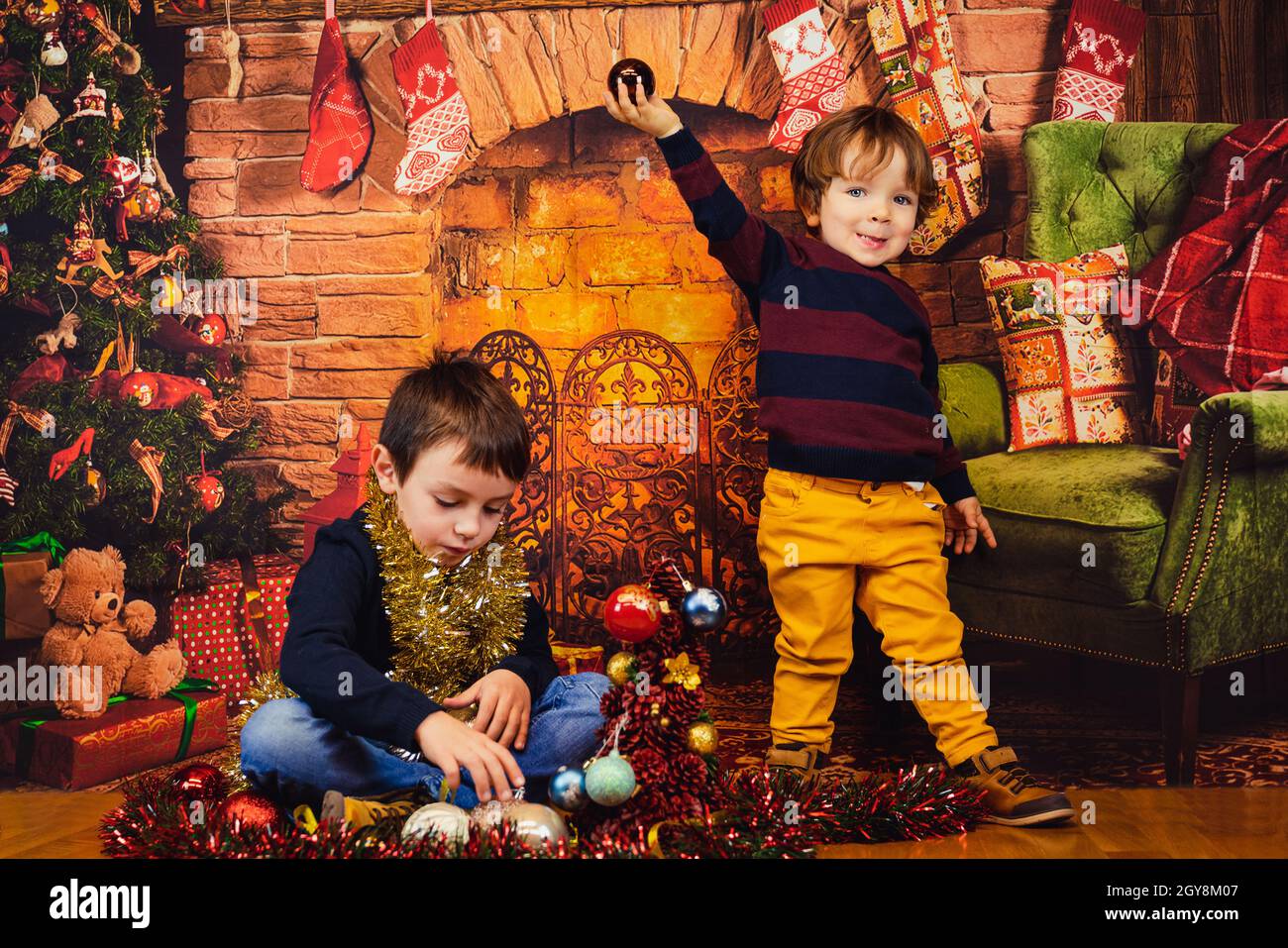 Two boys playing with Christmas decorations Stock Photo - Alamy