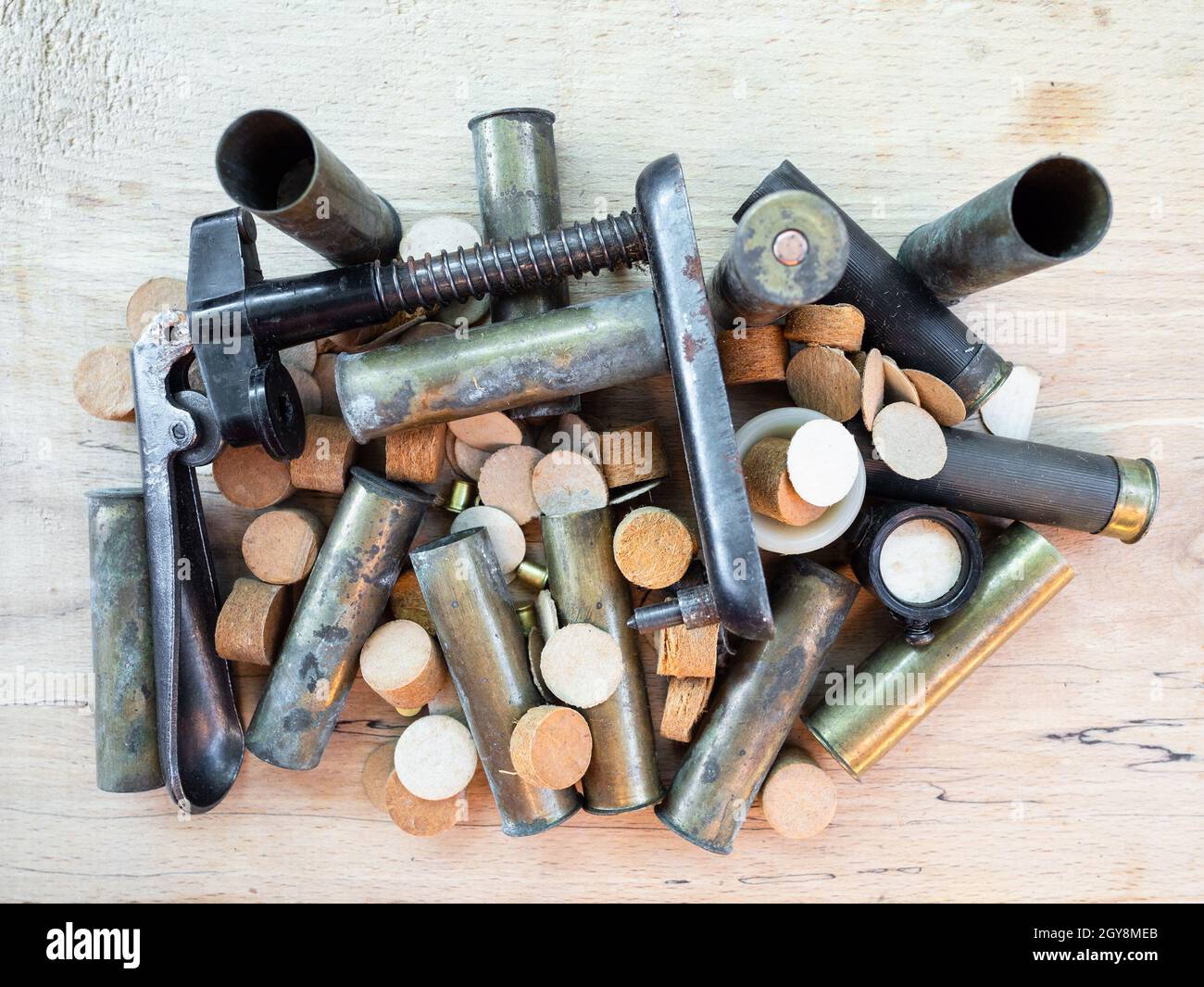 top view of reloading press over cartridge cases, wads, primers on ...