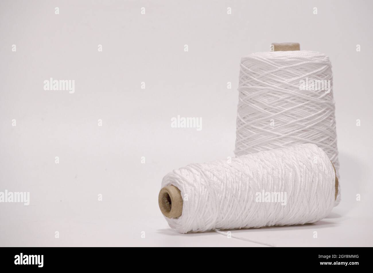 Roll of white rope for tying parcels on white background Stock Photo ...