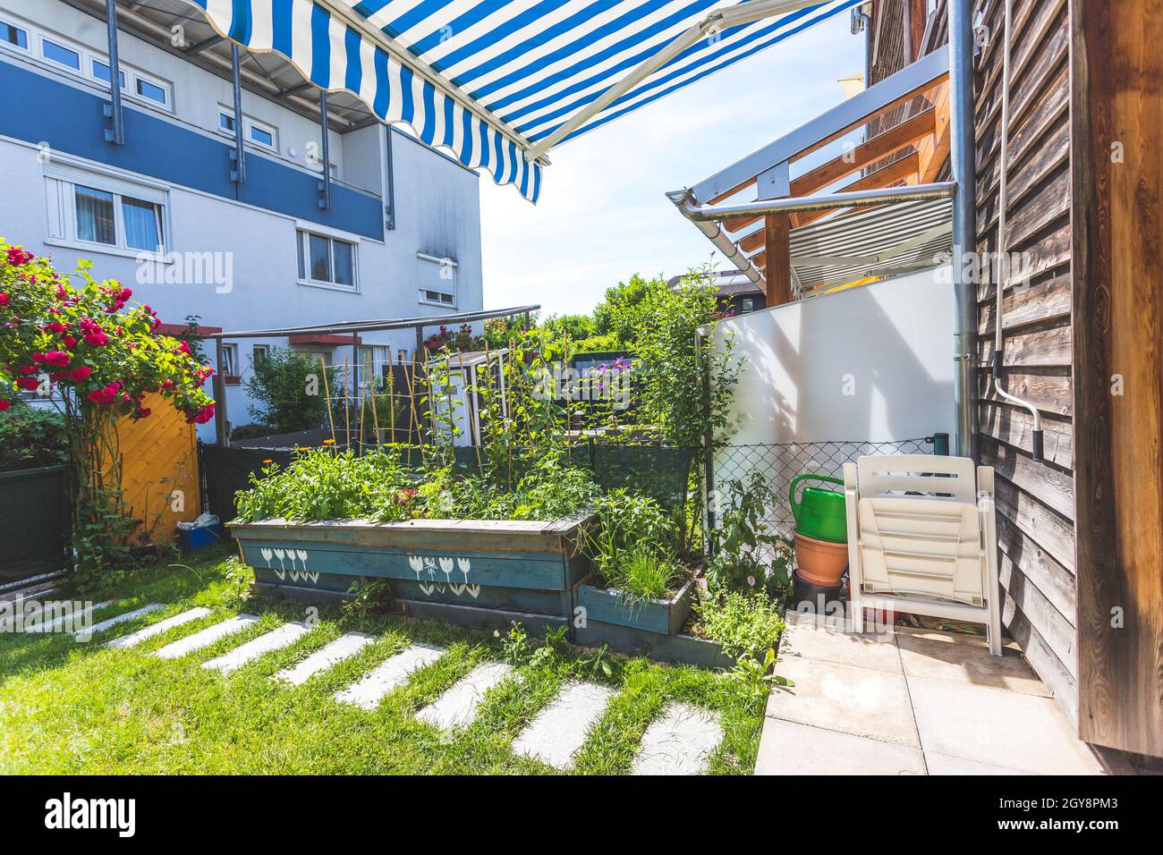 Cozy little green garden with raised bed and veranda, summer time Stock ...