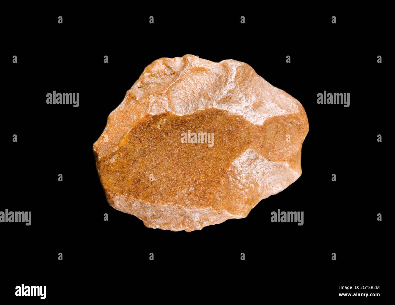 Flint stone isolated on a black background Stock Photo - Alamy