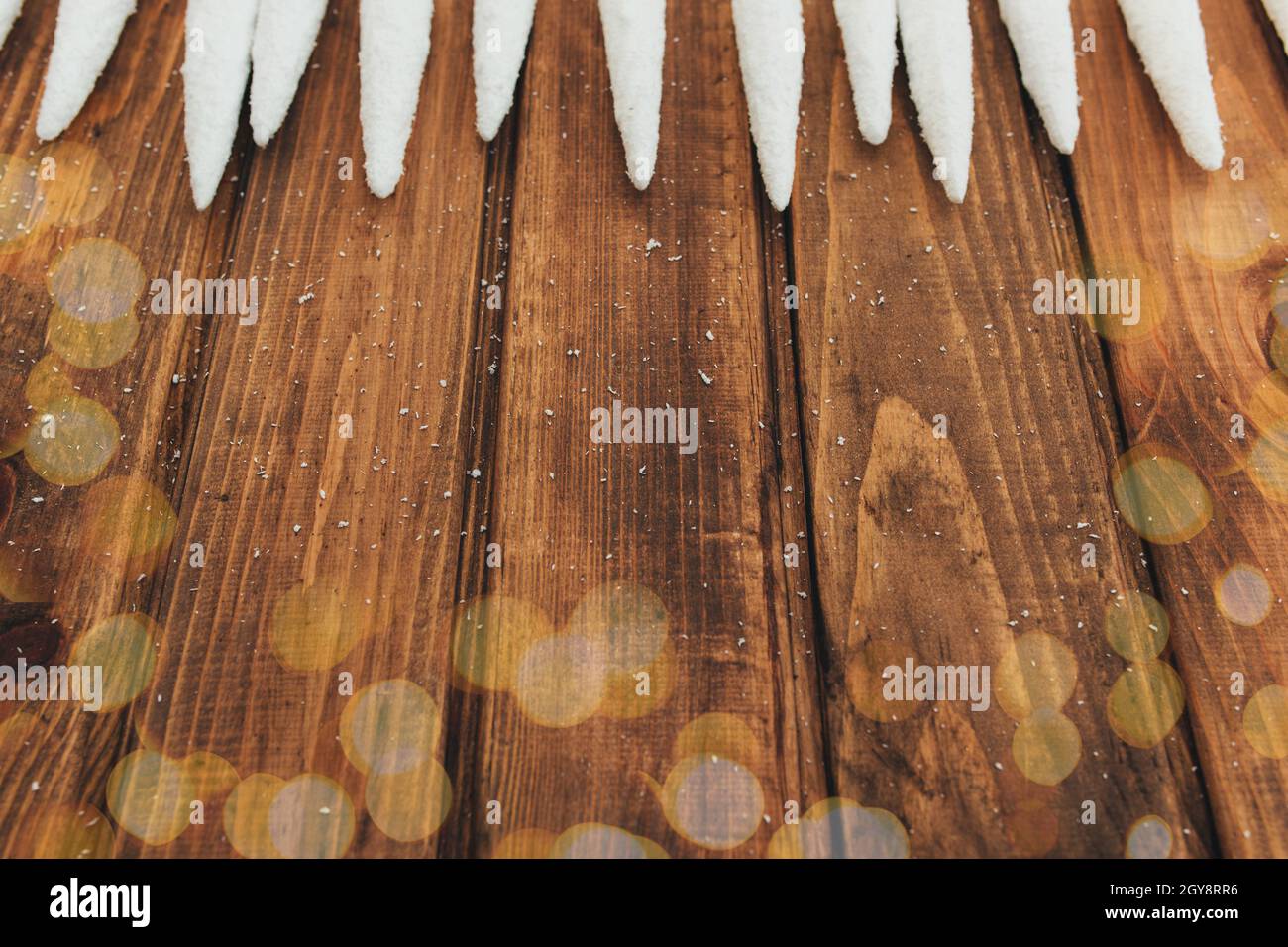 White icicles with yellow bokeh lights on brown wooden background . High quality photo Stock ...