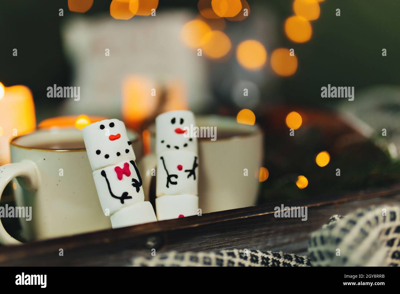 Marshmallow snowmans with cup of coffee, bokeh lights, christmas decoration. High quality photo ...