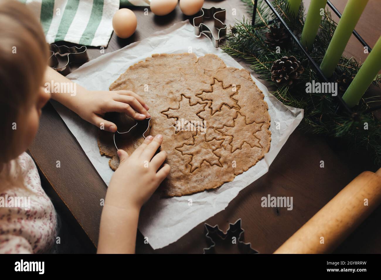 Little girl is baking christmas gingerbread cookies. High quality photo ...