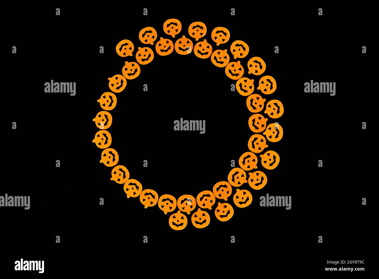 Bright orange pumpkins are arranged in a circle and a semicircle in two ...