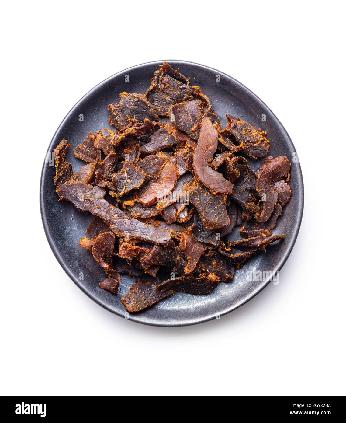 Sliced beef jerky. Dried beef meat on plate isolated on white ...