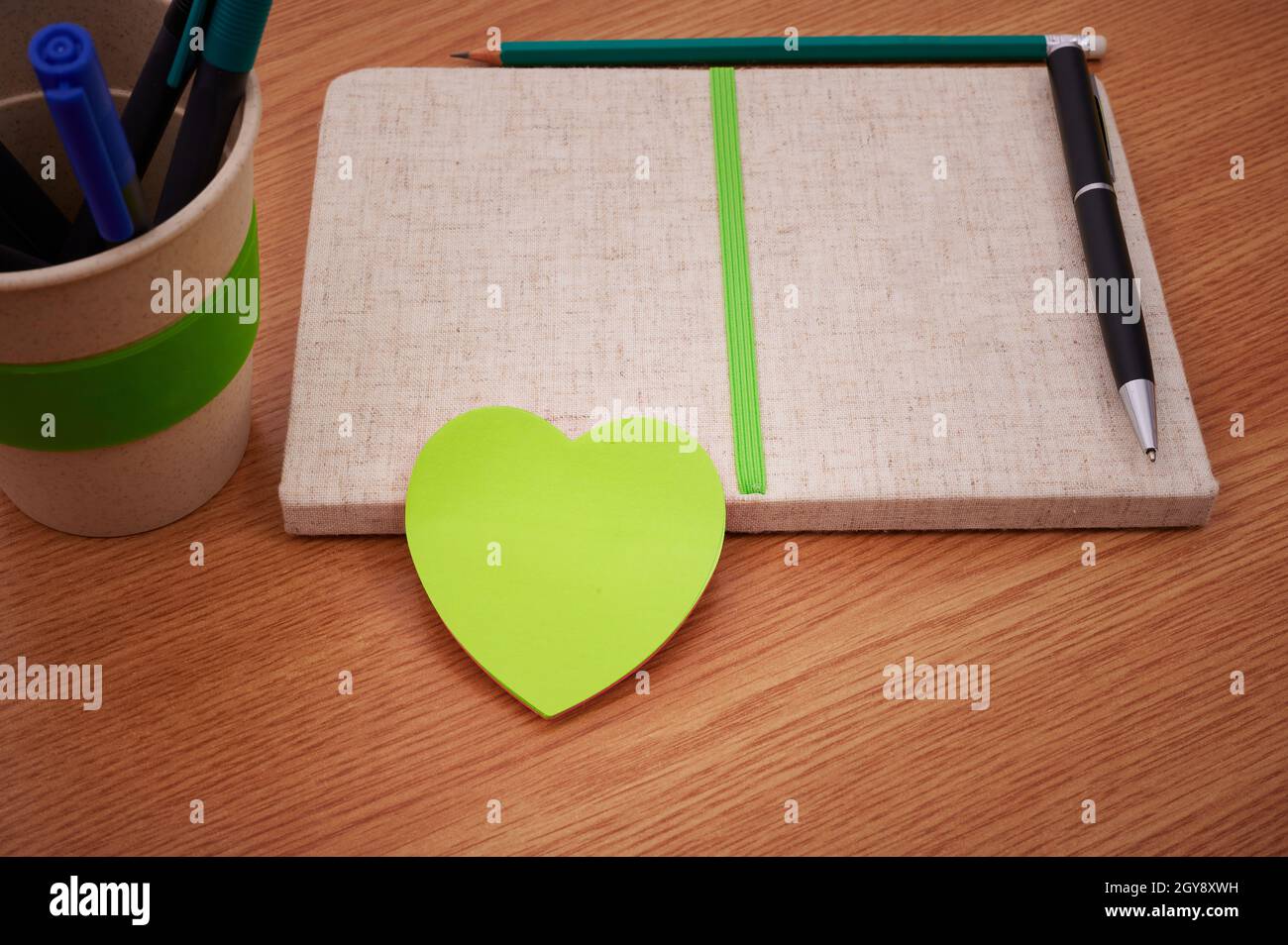 Plain Blank Open Notebooks With Stack Of Pens Container Over Table ...