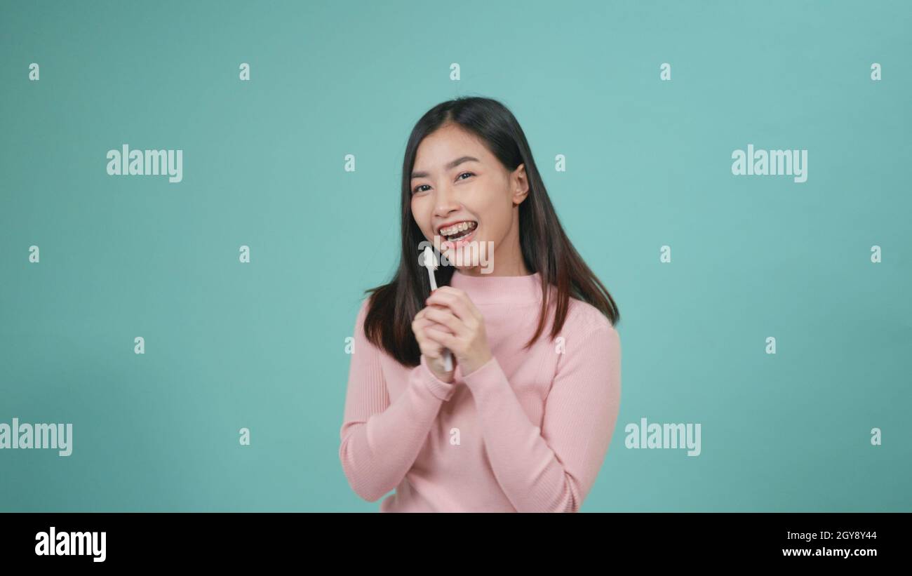 Asian young beautiful woman smile brushing teeth dancing enjoying music ...