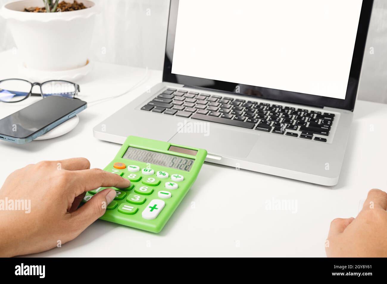 Accountant working and analyzing financial calculating with calculator ...