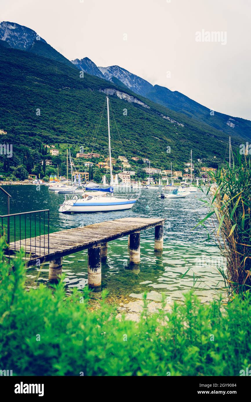 Dock pier in Italy, boats in the background Stock Photo - Alamy