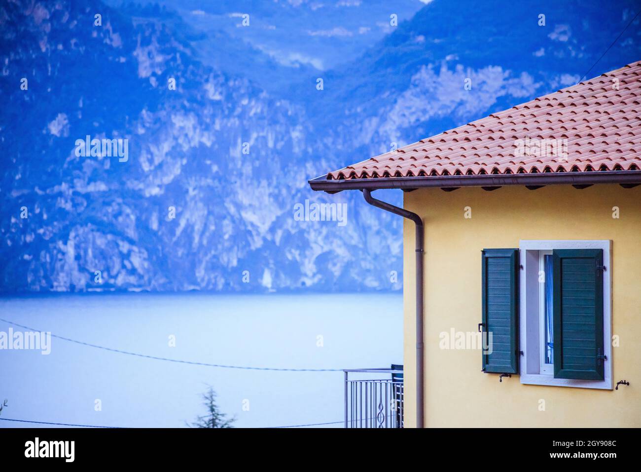 Italian evening scenery: House and mountain range, colorful sky Stock ...