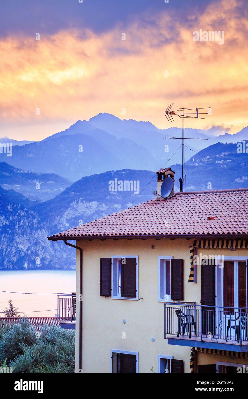 Italian evening scenery: House and mountain range, colorful sky Stock ...