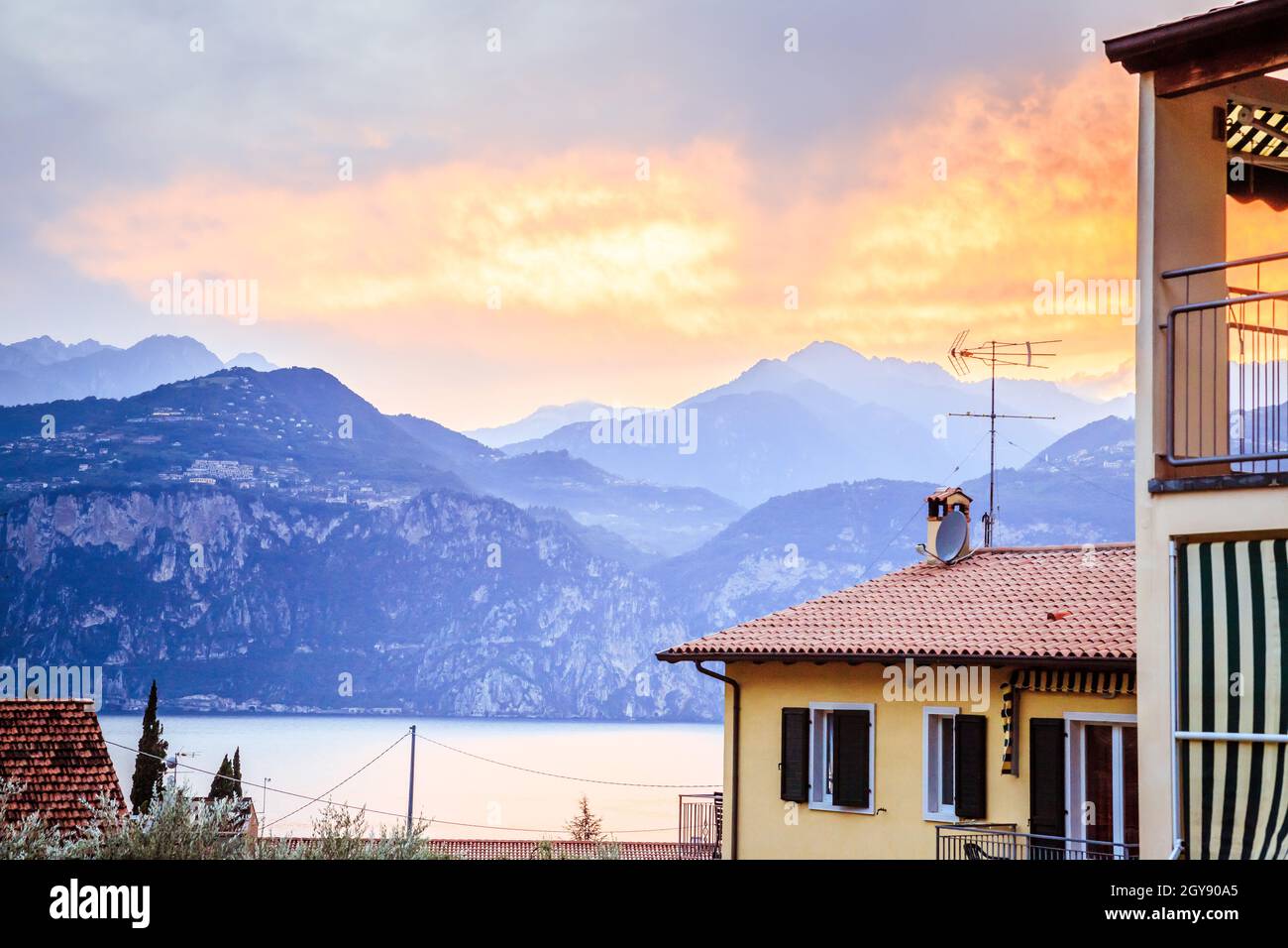 Italian evening scenery: House and mountain range, colorful sky Stock ...