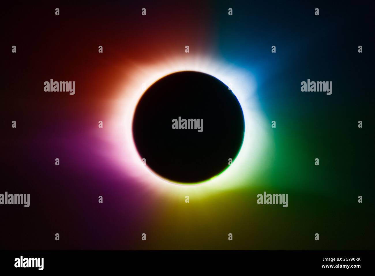 Solar eclipse with rainbow of colors and a black center Stock Photo - Alamy