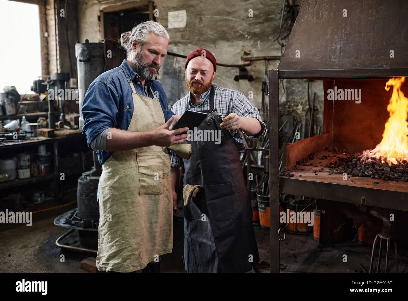 Two manual workers using digital tablet in their work while working in ...