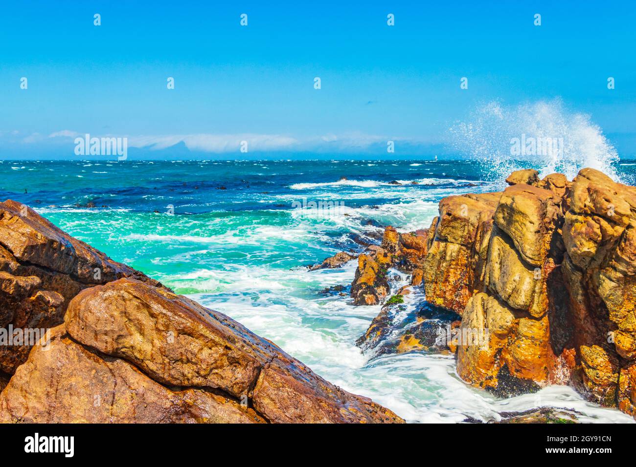 False Bay rough coast landscape with boulders waves and mountains with ...